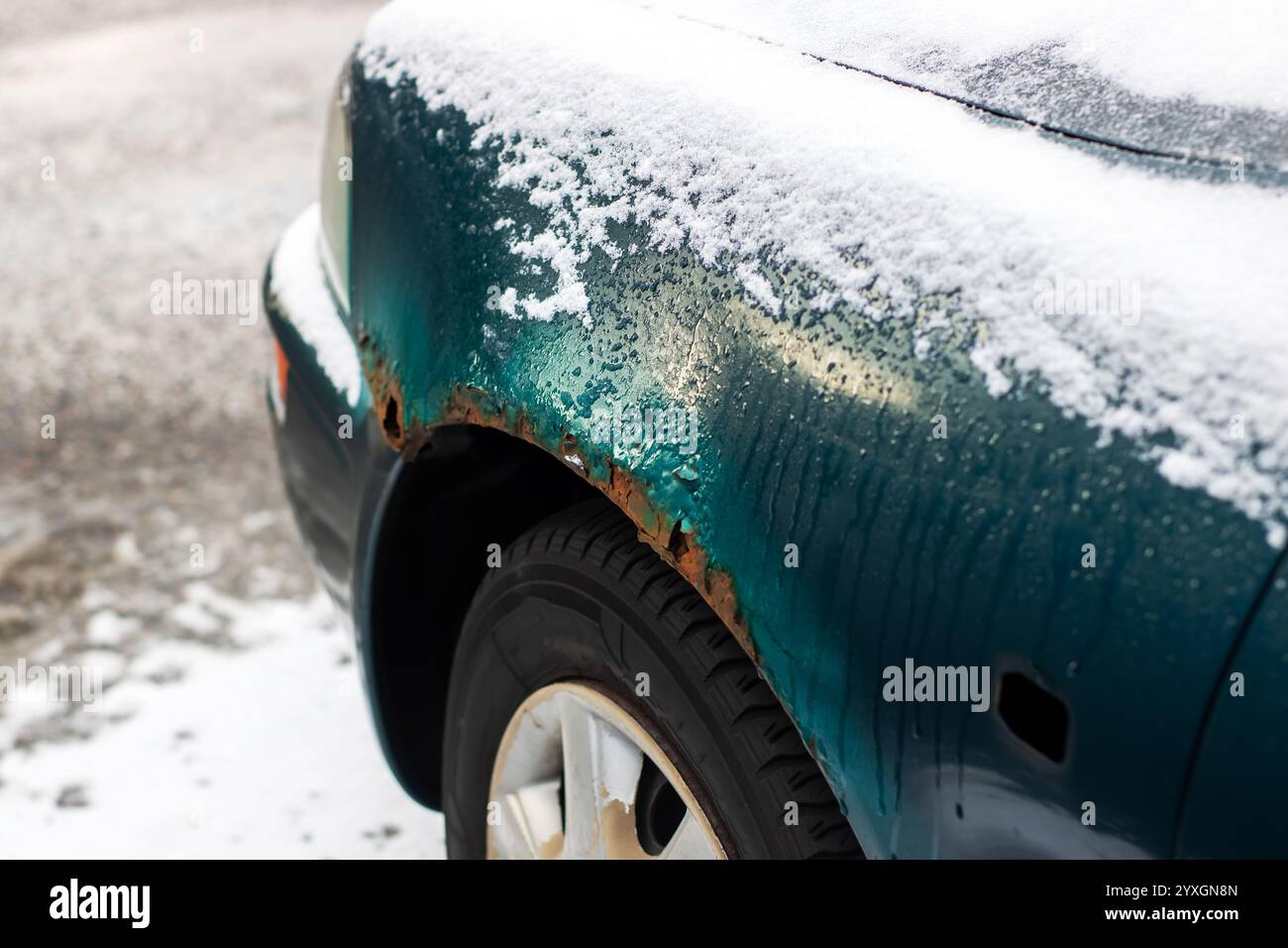 A green car that stands out is completely covered in a thick layer of ...