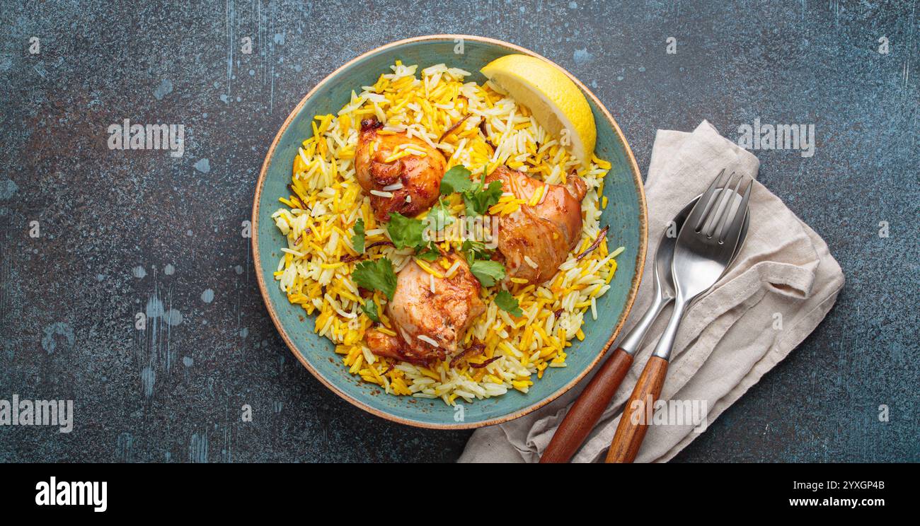 Traditional Indian dish chicken biryani with cilantro and lemon in a ...