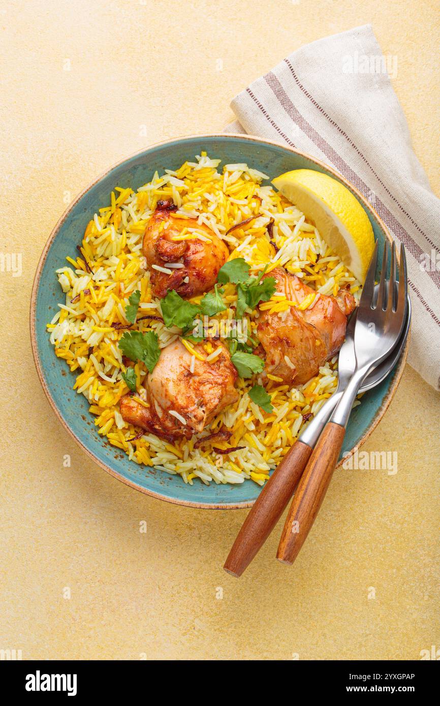 Traditional Indian dish chicken biryani with cilantro and lemon in a ...