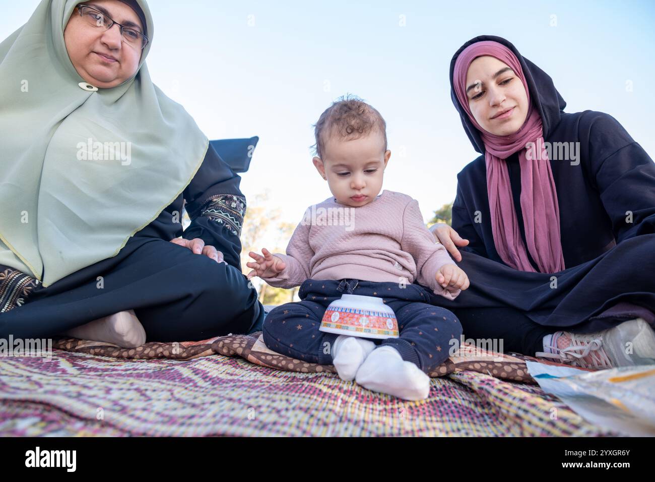 A joyful family moment featuring parents playing with their child in a ...