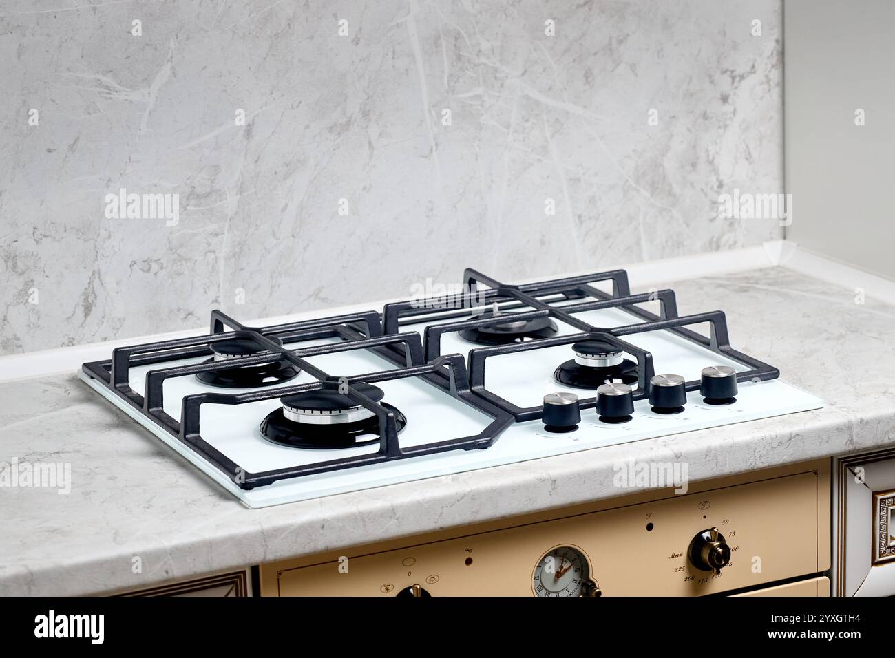 Modern white gas stove on counter top closeup. Hob gas stove made of ...