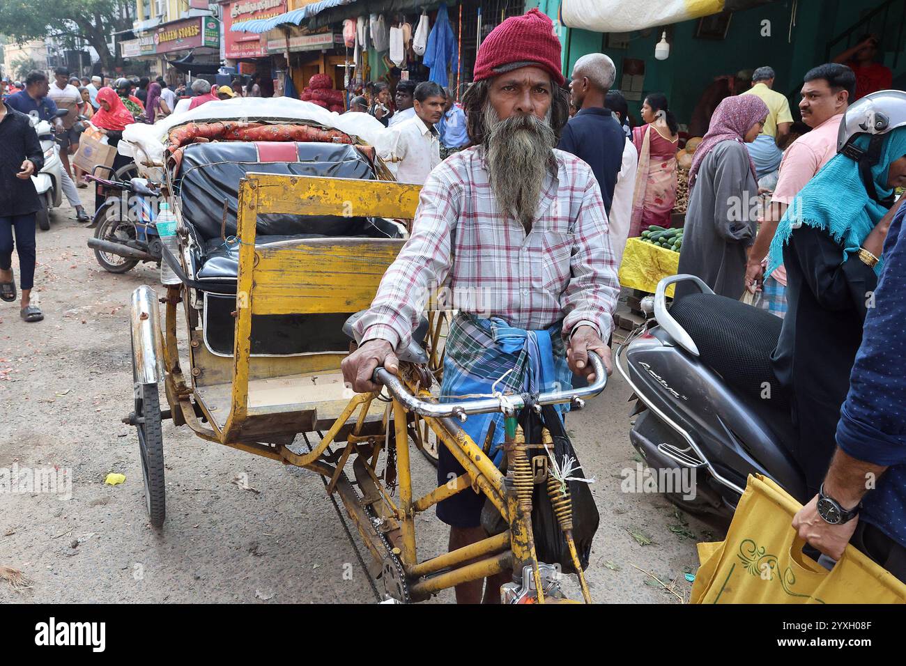 Portriat of a cycle rickshaw driver in the George Town district of ...