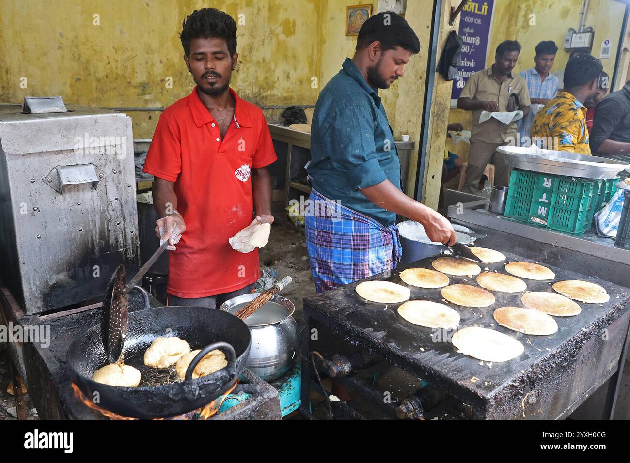 Vendors making puri and dosa at a food stall in Chennai, Tamil Nadu ...