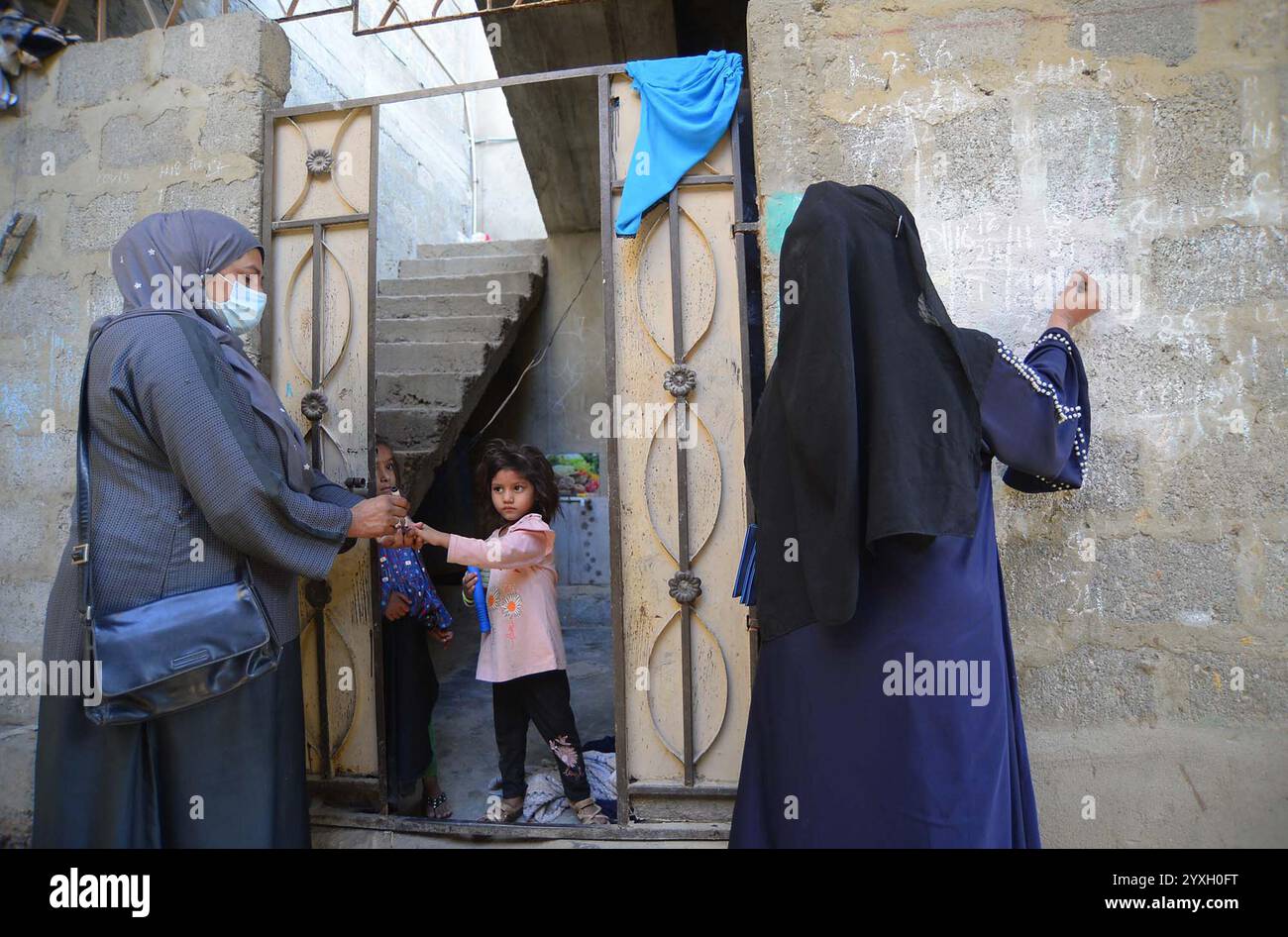 Health worker administrates polio-vaccine drops to a child during anti ...