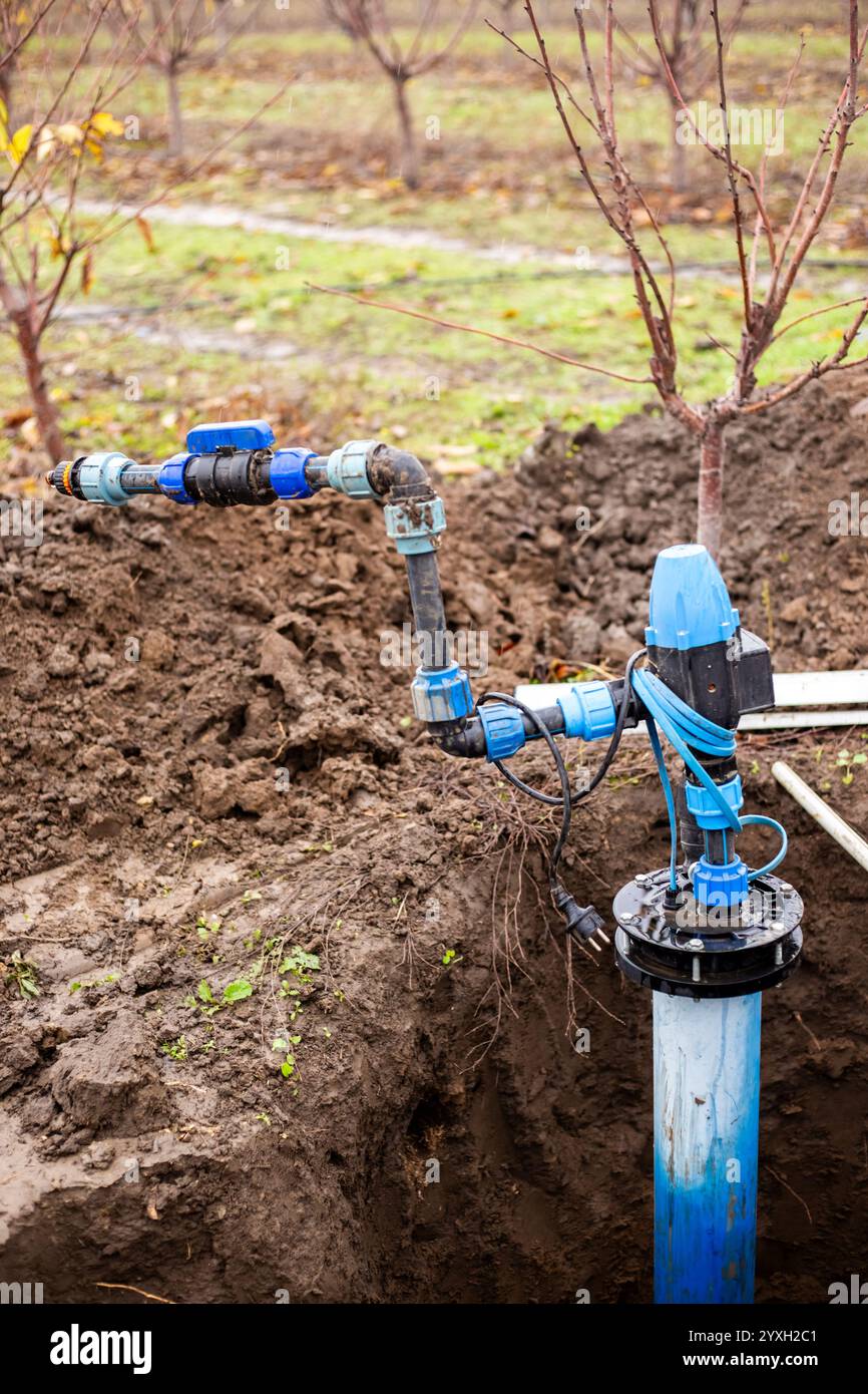water intake unit in a well dug in the ground. Installation of a water ...