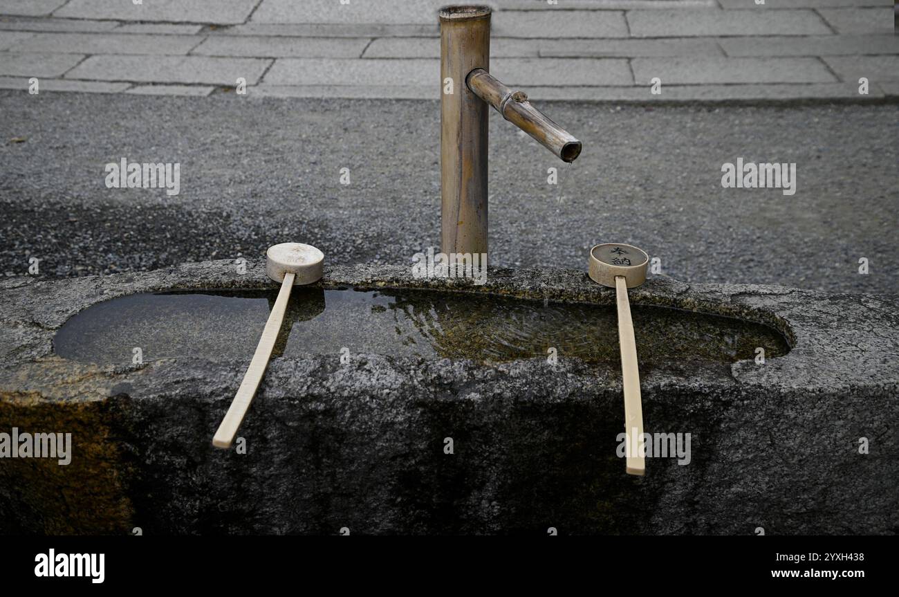 Traditional Japanese Tsukubai stone water basin with handcrafted bamboo ...