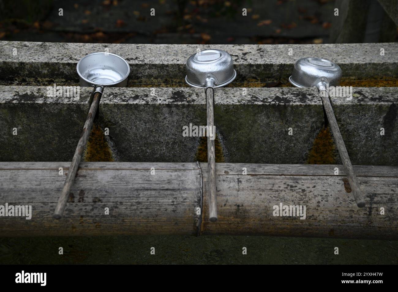 Traditional Japanese Tsukubai stone water basin with handcrafted pewter ...