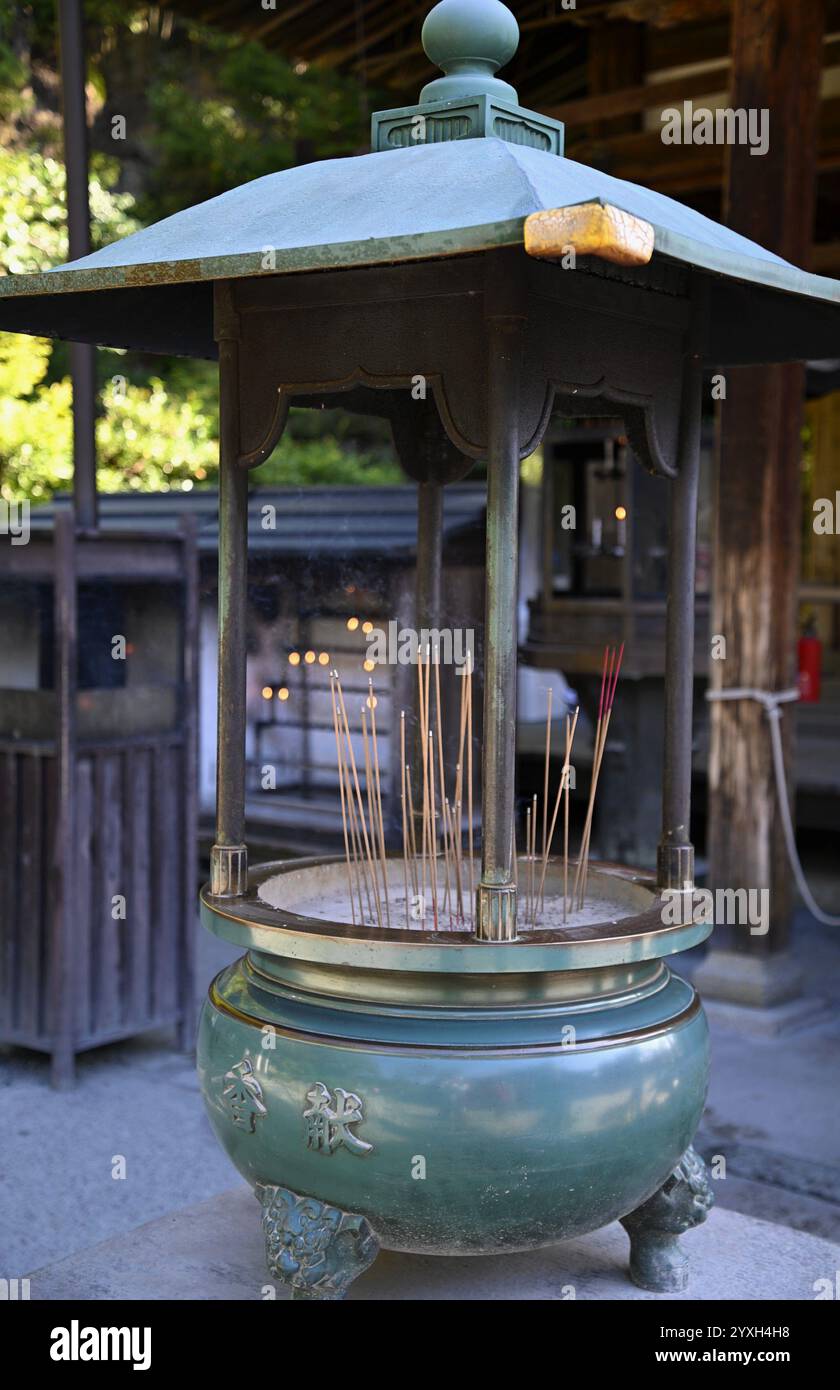 Shoyeido sandalwood incense sticks burning in a traditional antique ...