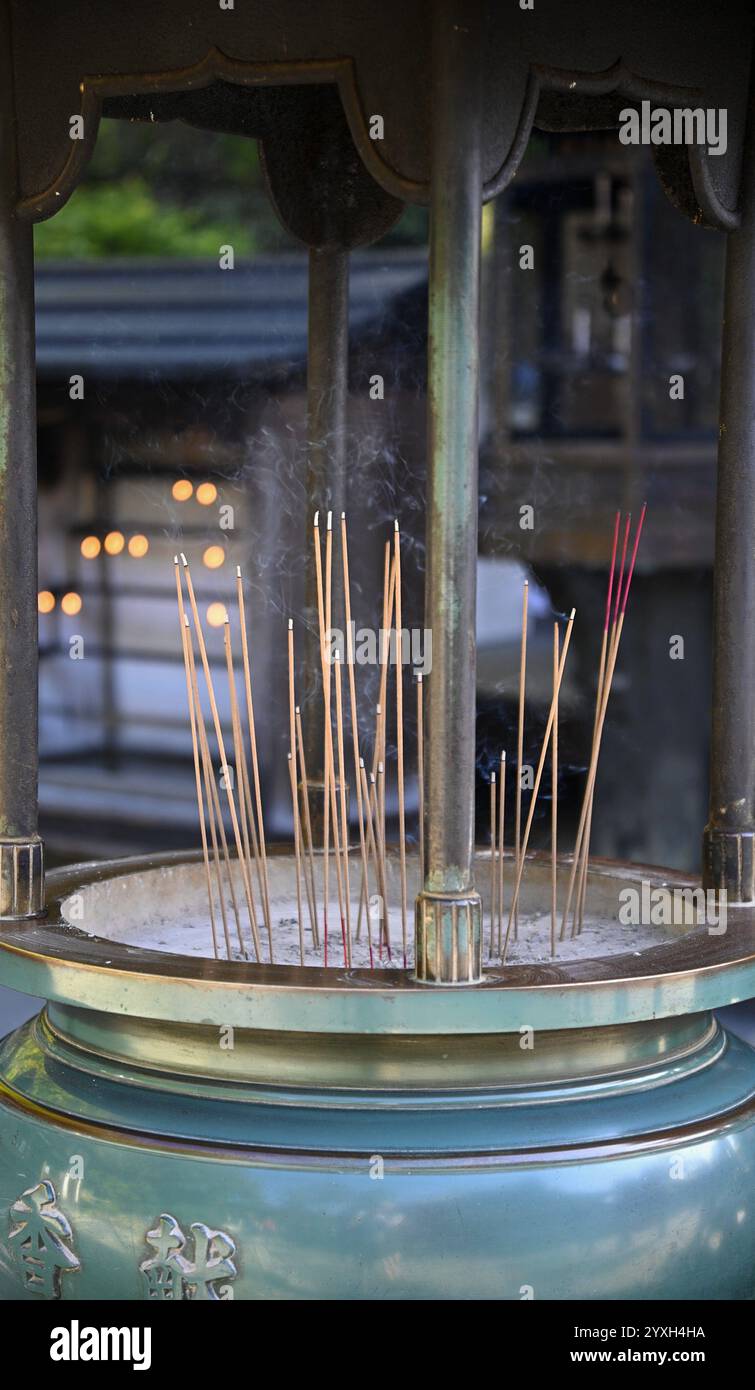 Shoyeido sandalwood incense sticks burning in a traditional antique ...
