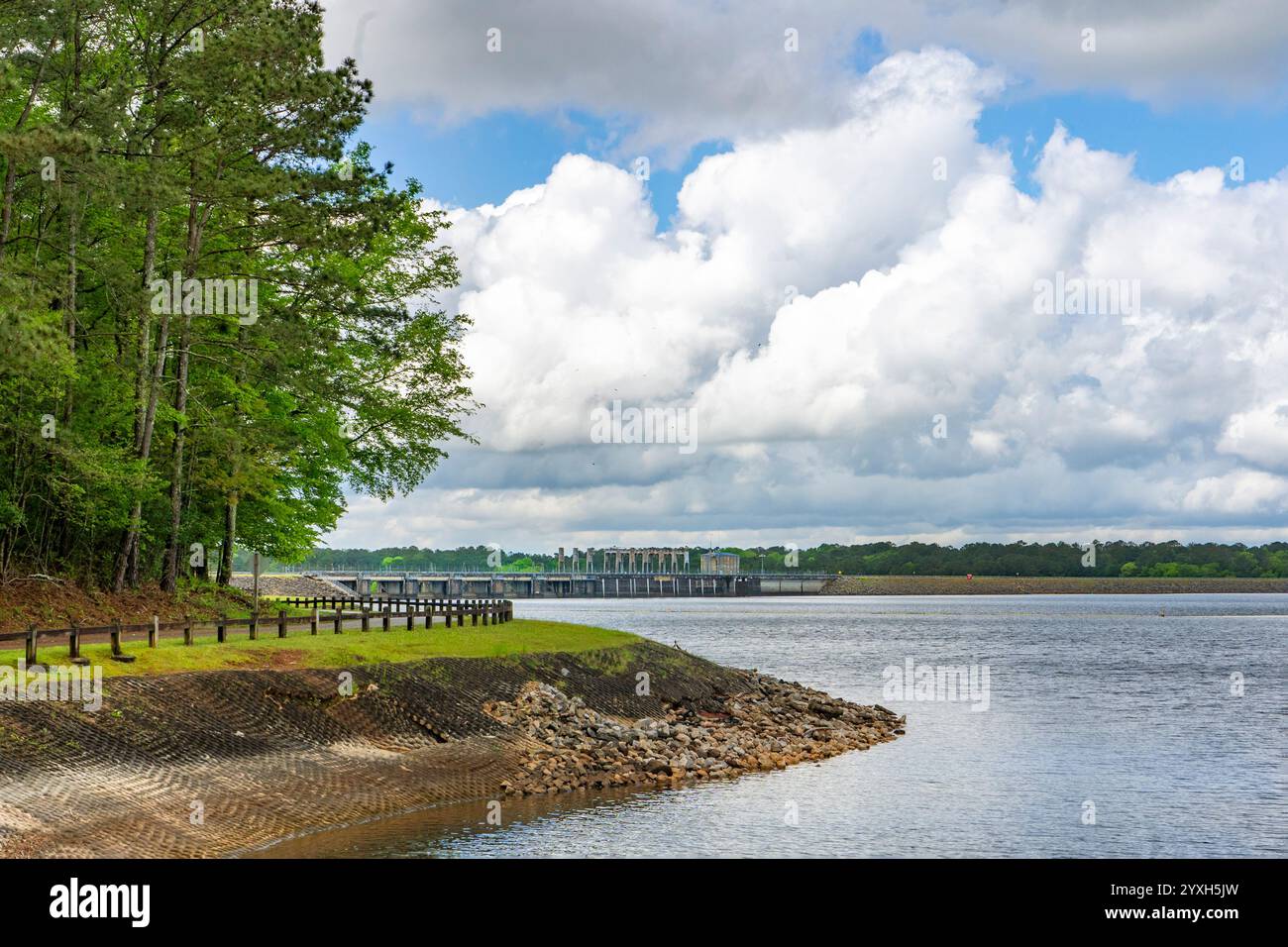 A view of the West Point Lake Dam under a clear blue sky with large ...