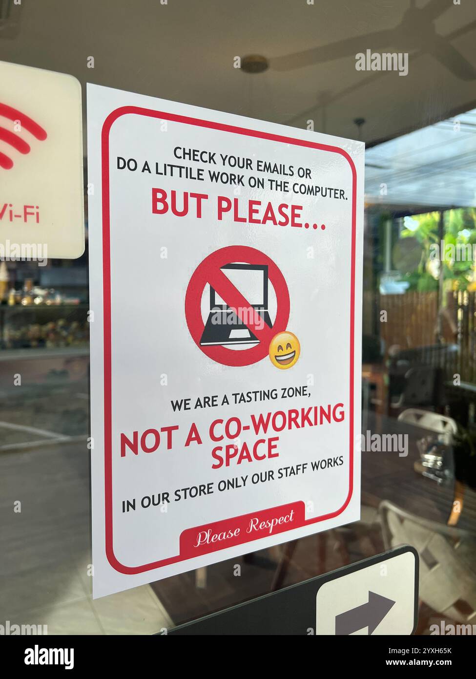Store window sign politely indicating it's not a co-working space ...