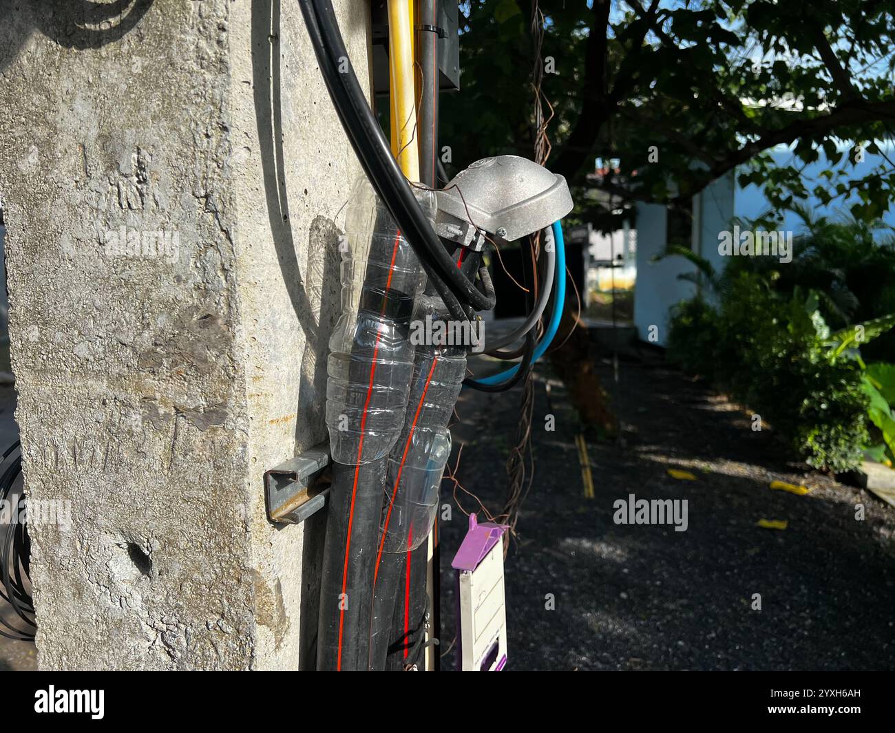 Water bottles used as makeshift electrical wire protection on a utility ...