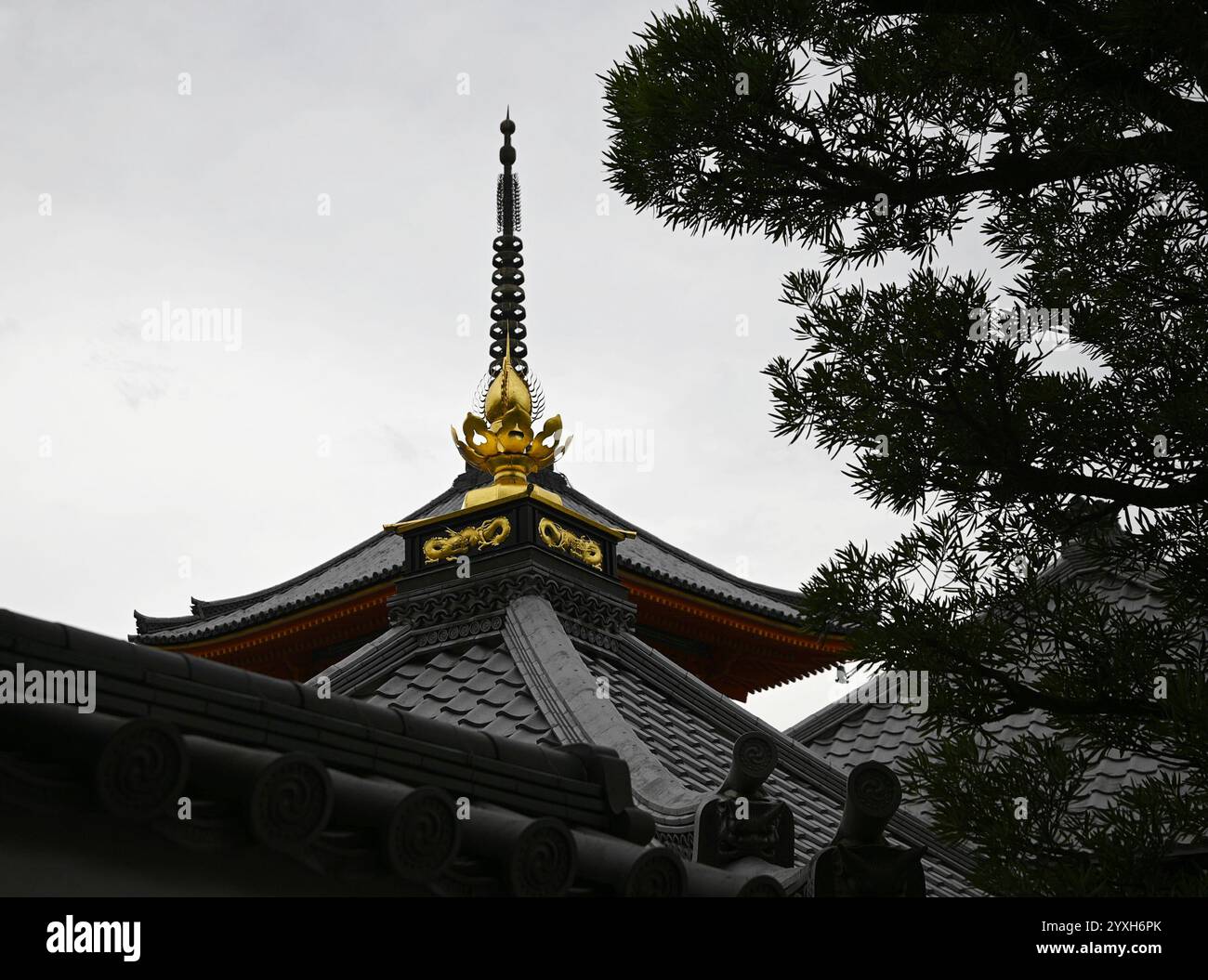 Rooftop architectural detail with a golden symbol at Kiyomizu-dera ...