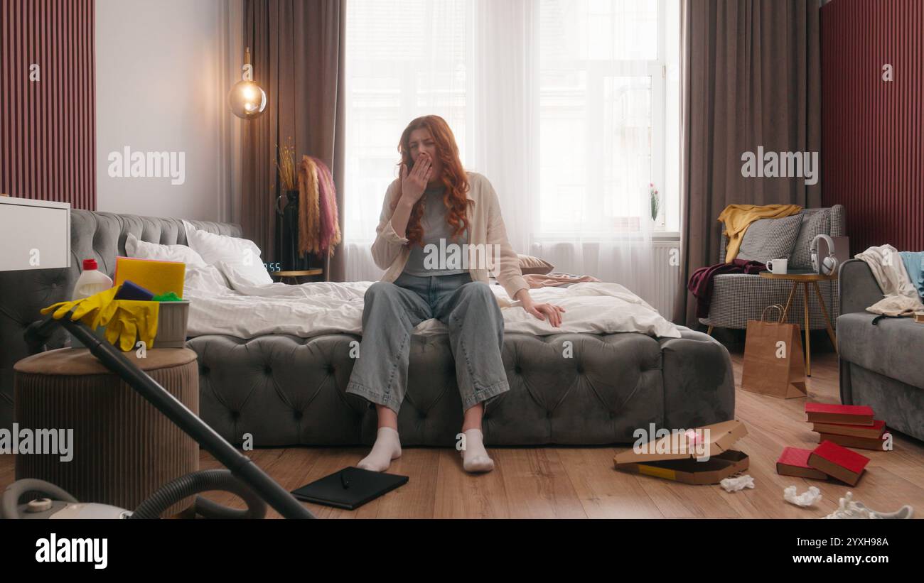 Tired girl Caucasian woman homeowner housekeeper female in bedroom mess ...
