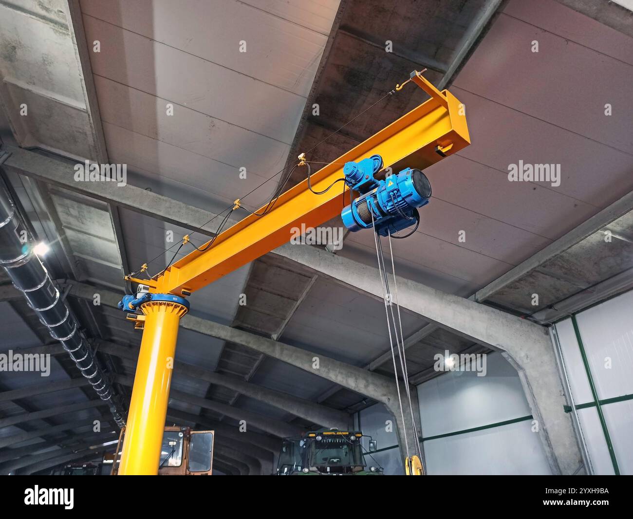 Indoor jib crane for repairing agricultural machinery Stock Photo - Alamy
