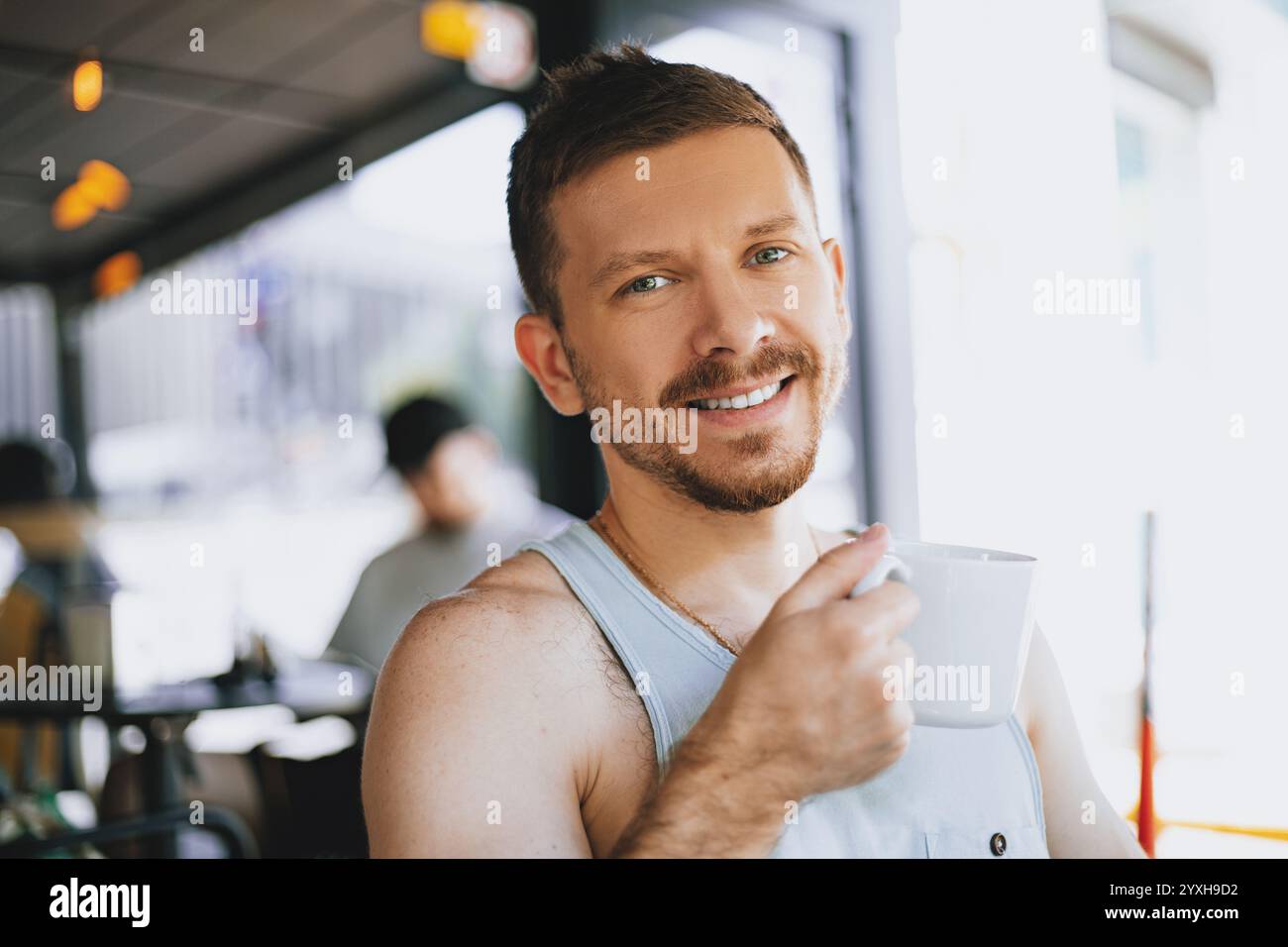 Happy man relaxing in cafe hi-res stock photography and images - Alamy