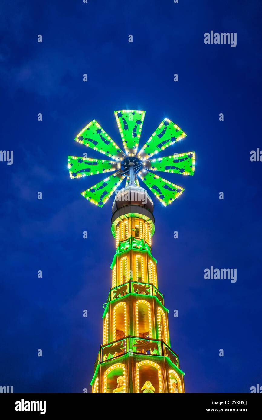 Illuminated Christmas pyramid with spinning blades at night. Concept of ...