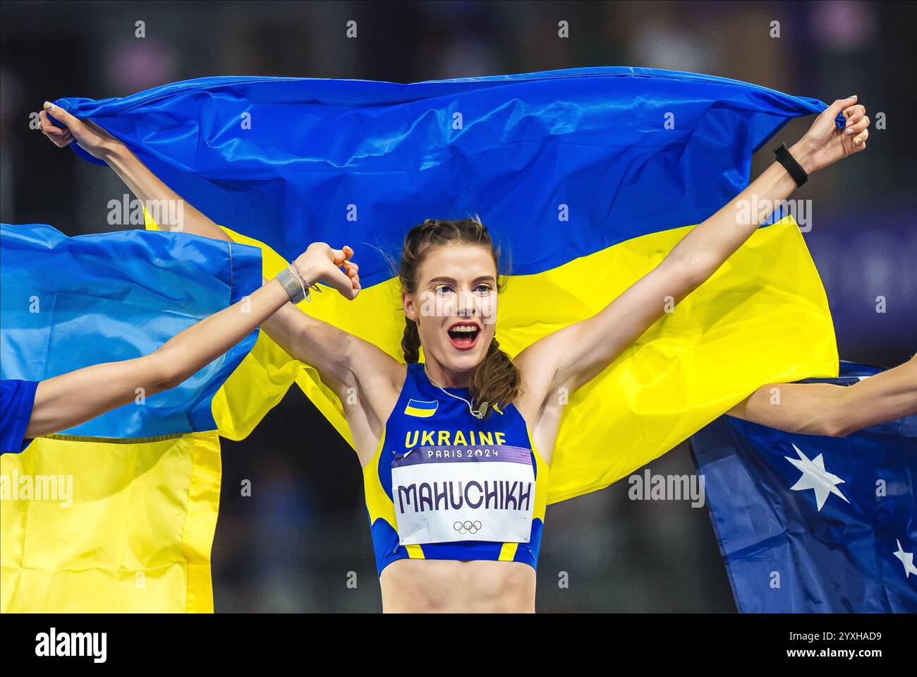 Yaroslava Mahuchikh celebrating her medal with her country's flag at ...