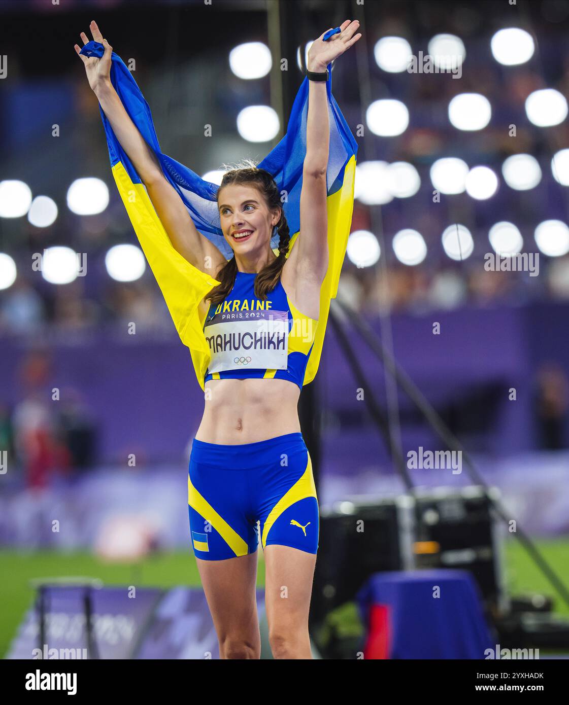 Yaroslava Mahuchikh celebrating her medal with her country's flag at ...