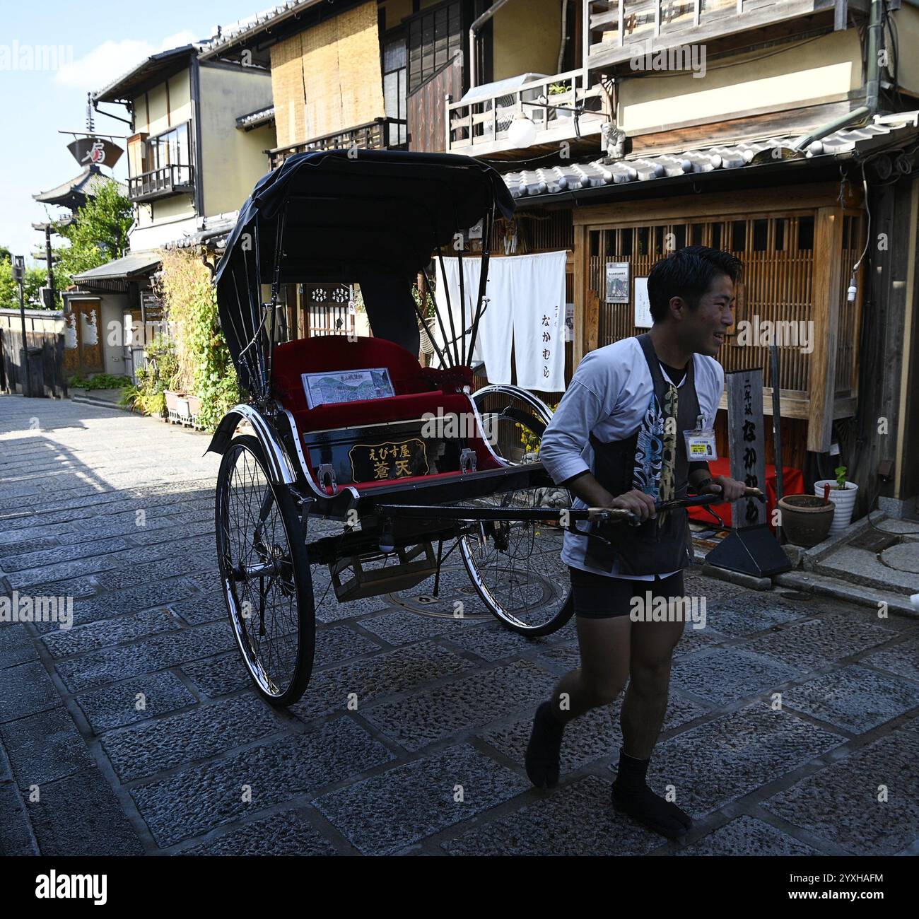 Traditional Japanese Jinrikisha rickshaw driver in action on the ...