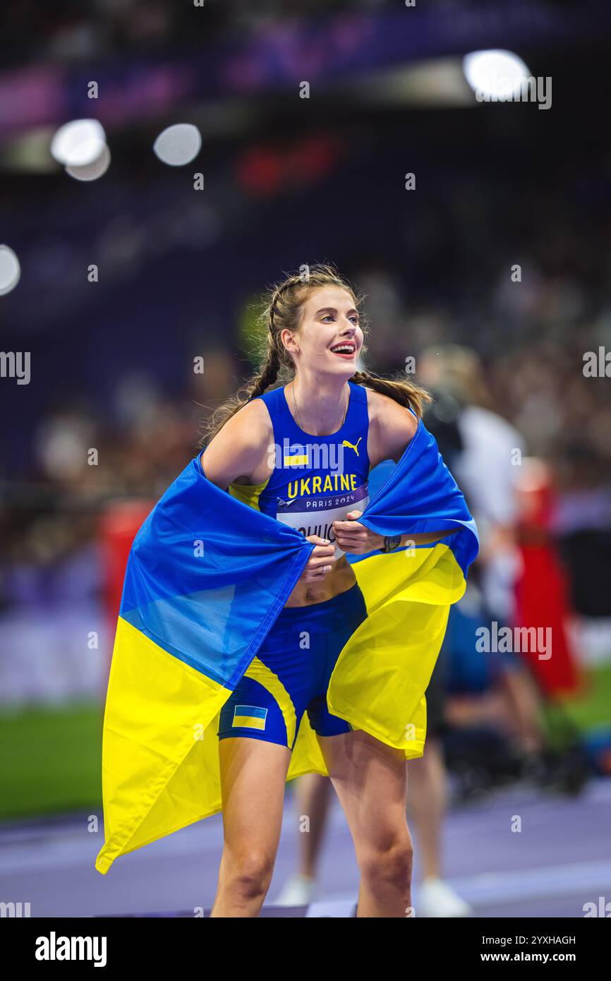 Yaroslava Mahuchikh celebrating her medal with her country's flag at ...
