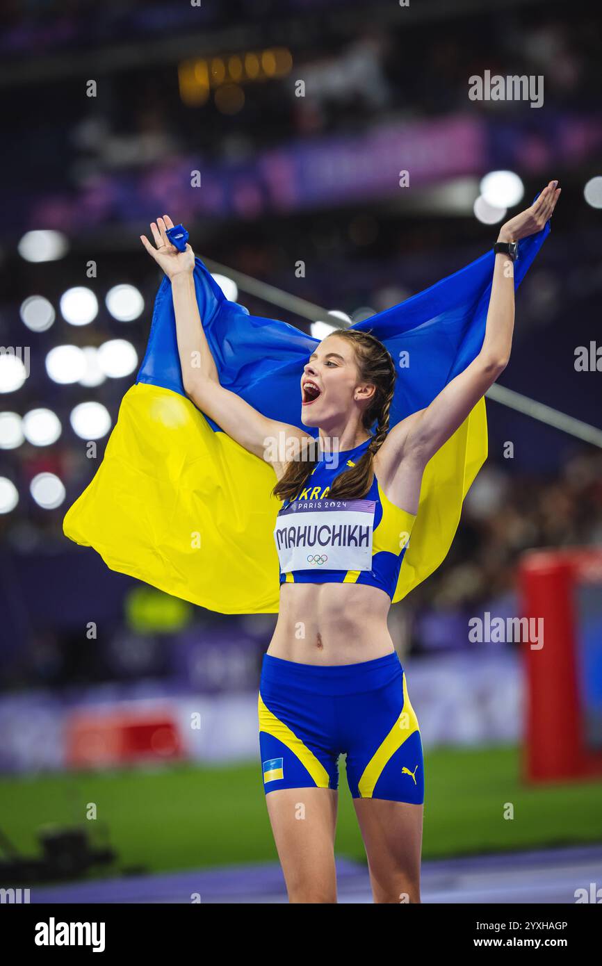Yaroslava Mahuchikh celebrating her medal with her country's flag at ...