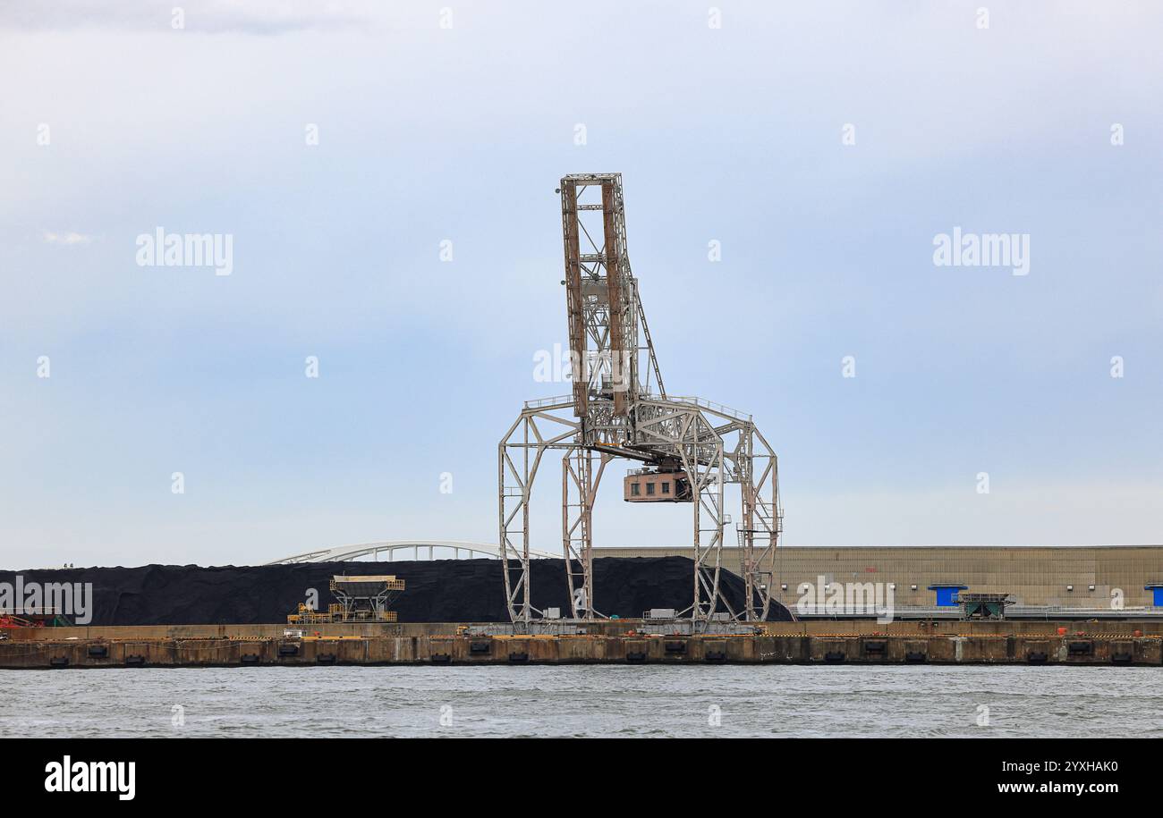 LargeLarge crane works on large coal stockpile at Osaka port. crane ...