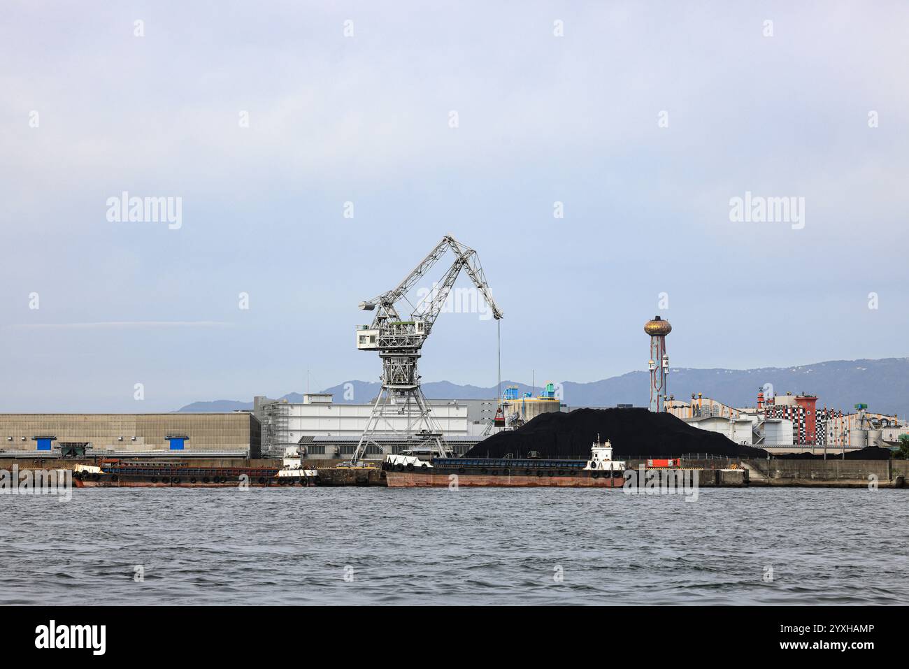 LargeLarge crane works on large coal stockpile at Osaka port. crane ...