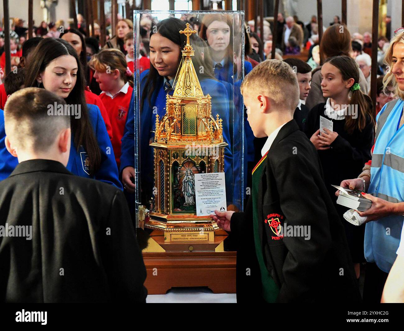 Pupils from schools in the Derry Diocese queue for the veneration of ...