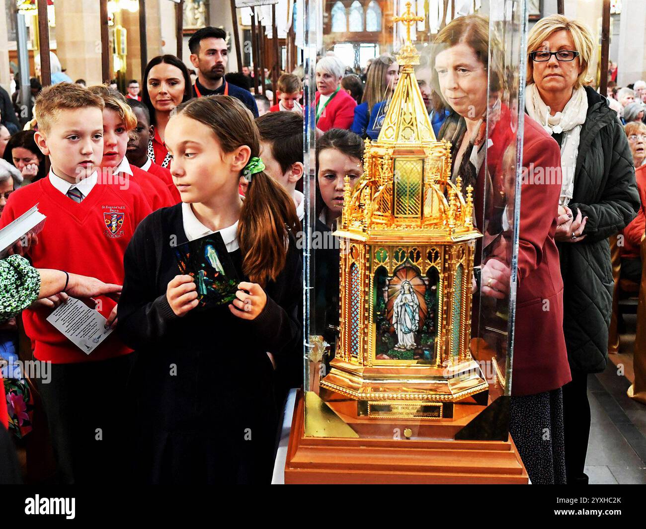 Pupils from schools in the Derry Diocese queue for the veneration of ...