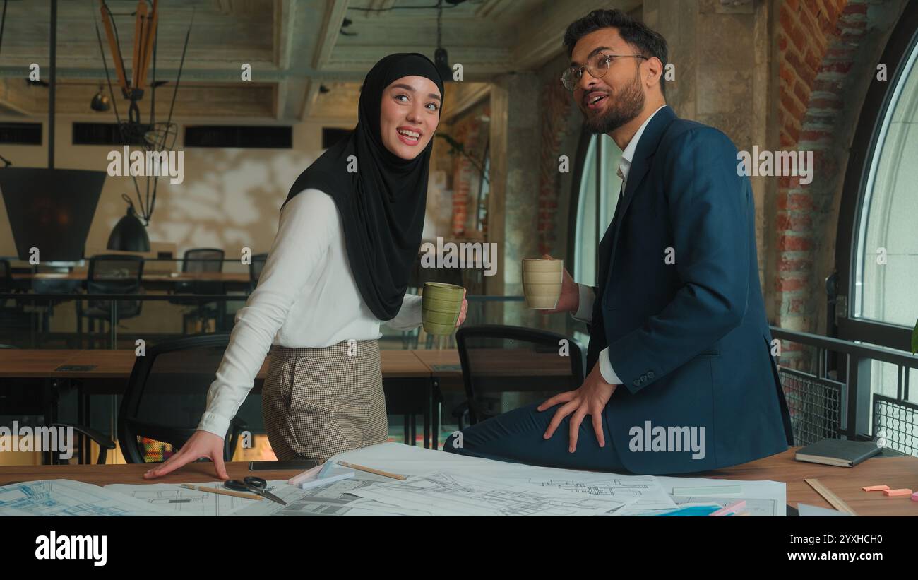 Two architects contractors engineers colleagues architecture project Arabian muslim designers ...