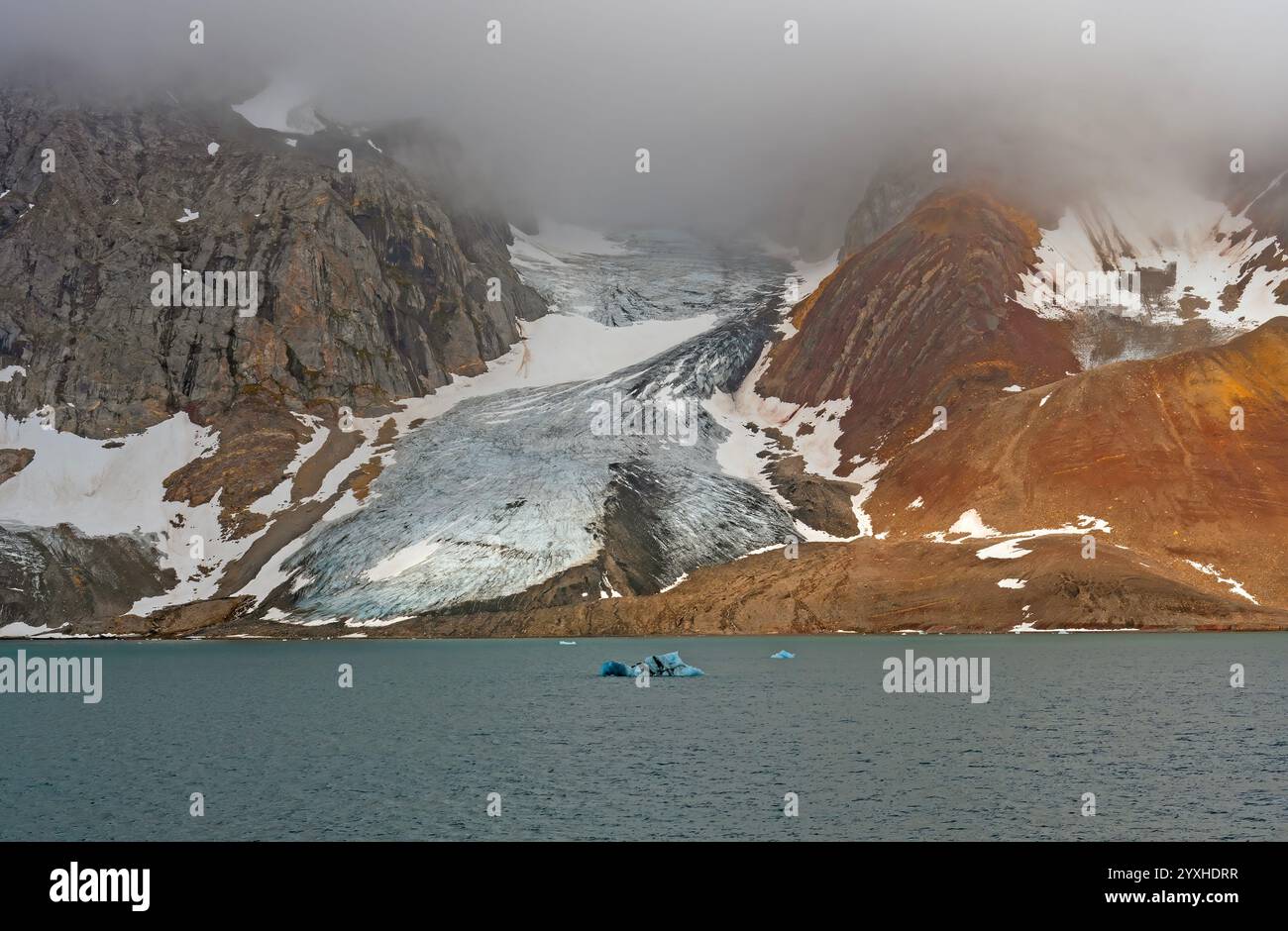 Glacier Cutting Through Colorful Mountains on a Foggy Morning in ...