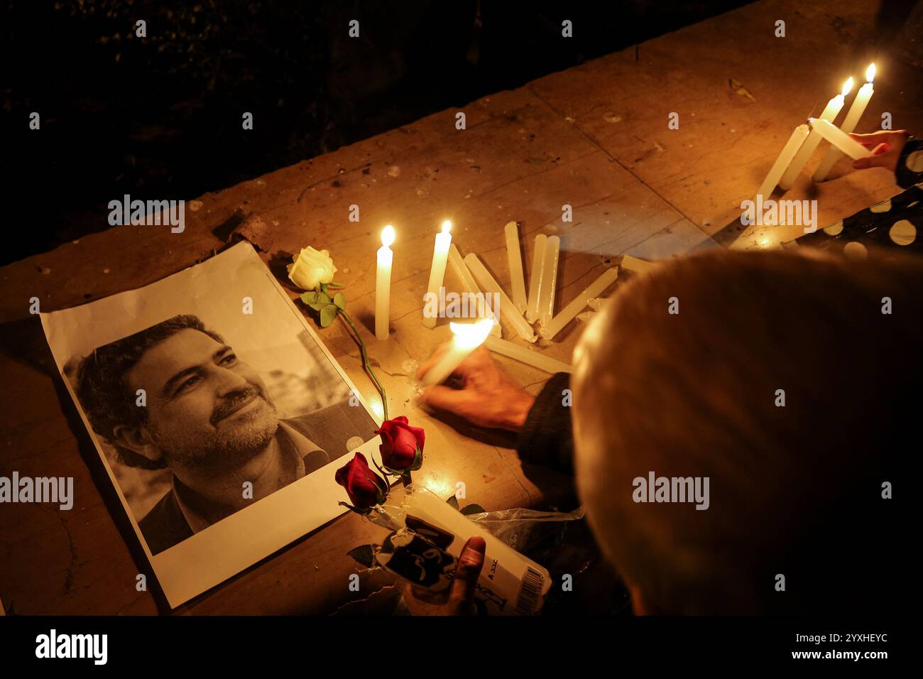 Beirut, Beirut, Lebanon. 16th Dec, 2024. Candles are lit near a picture ...
