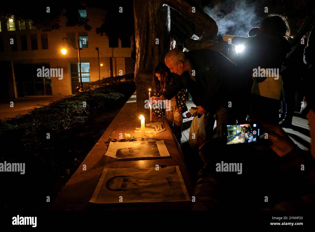 Beirut, Beirut, Lebanon. 16th Dec, 2024. Candles are lit near a picture ...