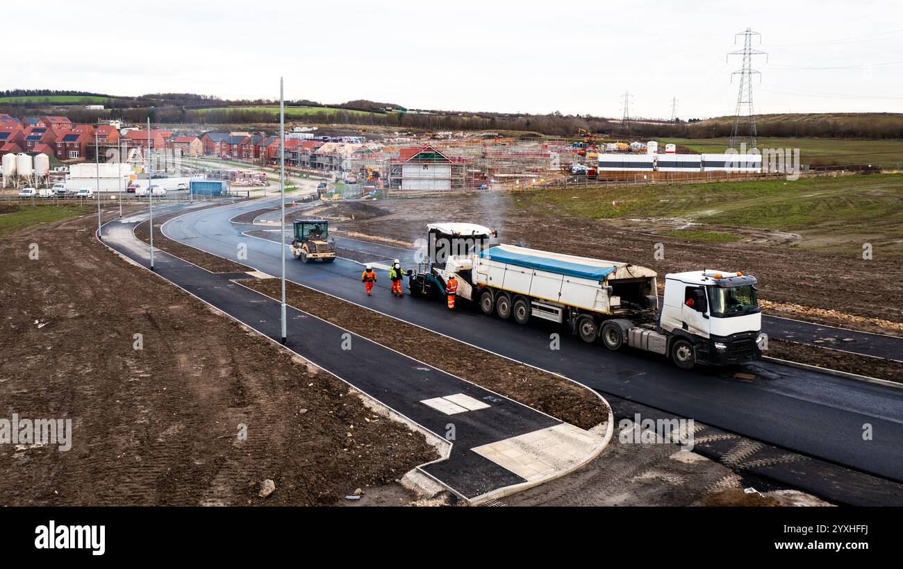 Aerial view of a tramac road surfacing machine creating a new road and infrastructure on a new ...
