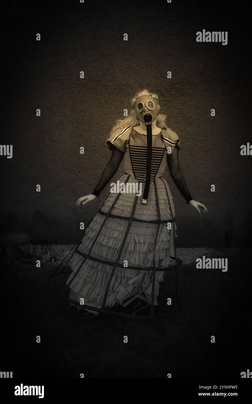 Portrait of a pretty girl cosplayer dressed in old fashioned gas mask ...