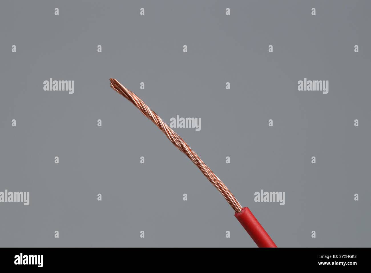 Red stripped electrical wire on light grey background, closeup Stock ...