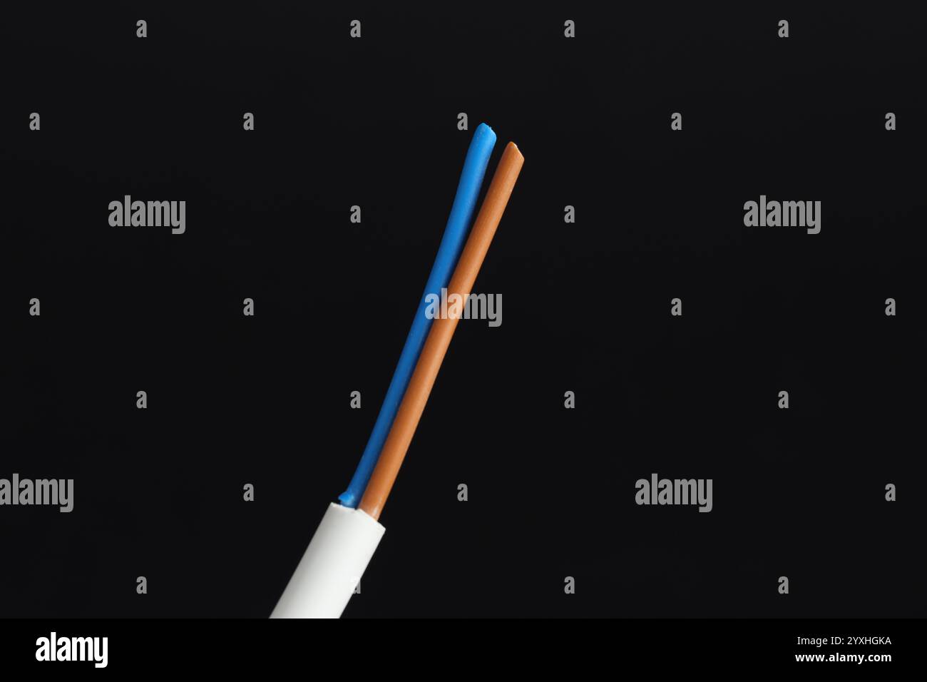 White stripped electrical wire on black background, closeup Stock Photo ...