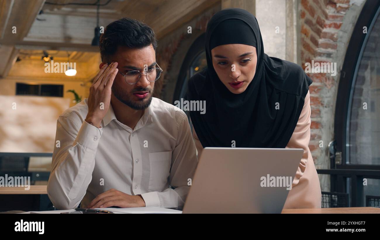 Two business colleagues co-workers talk discuss corporate work at ...