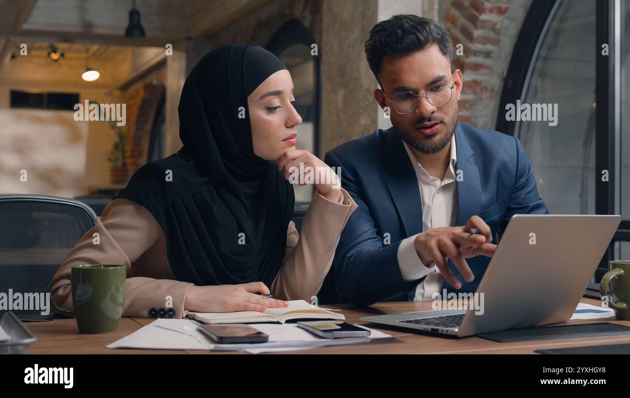 Two business colleagues co-workers talk discuss corporate work at ...