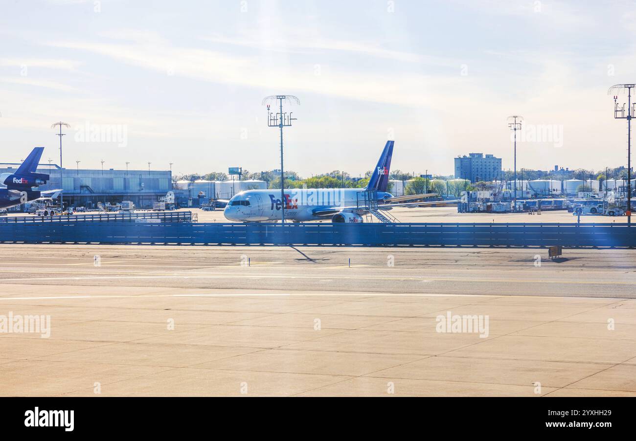 FedEx cargo planes parked on tarmac at busy airport during clear sunny ...