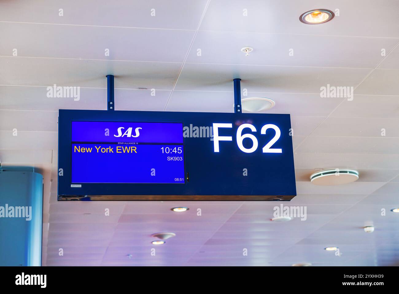 Gate sign F62 for SAS flight SK903 departing at 10:45 to New York EWR ...