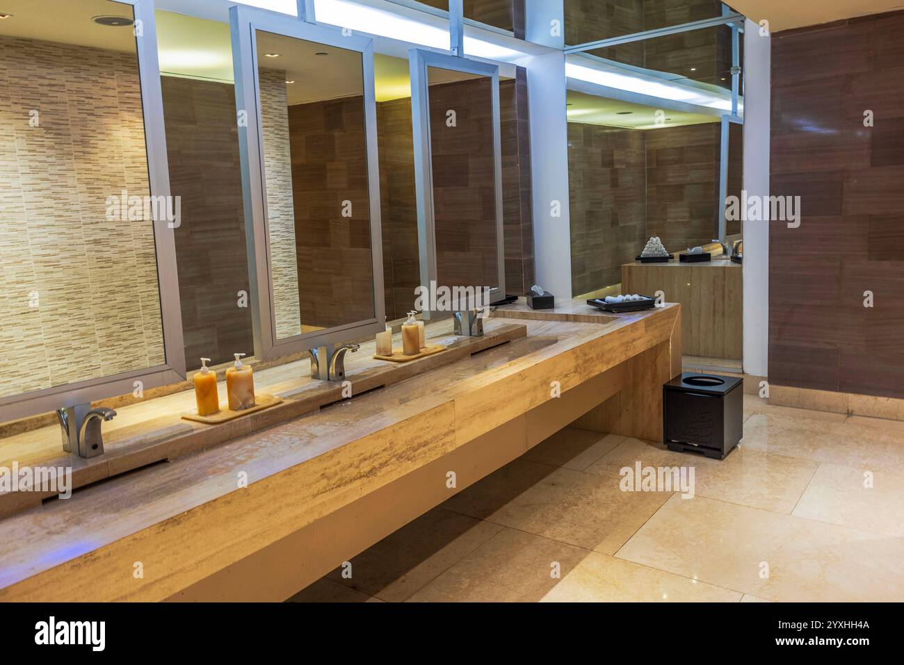 Luxury hotel restroom interior with marble sinks, modern mirrors, and ...