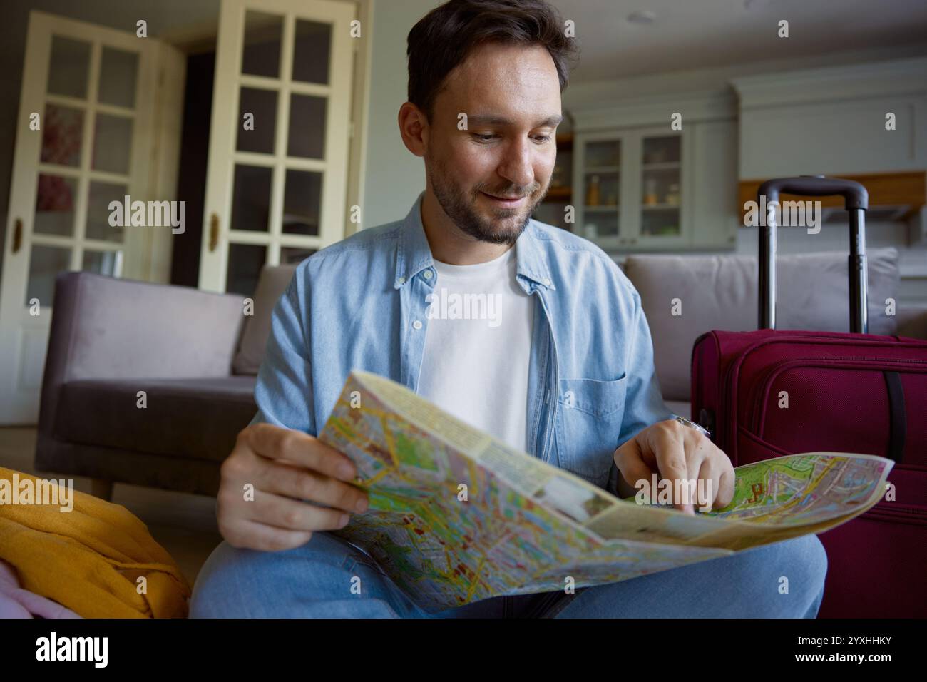 Man tourist searching place of destination for travel reading paper map ...