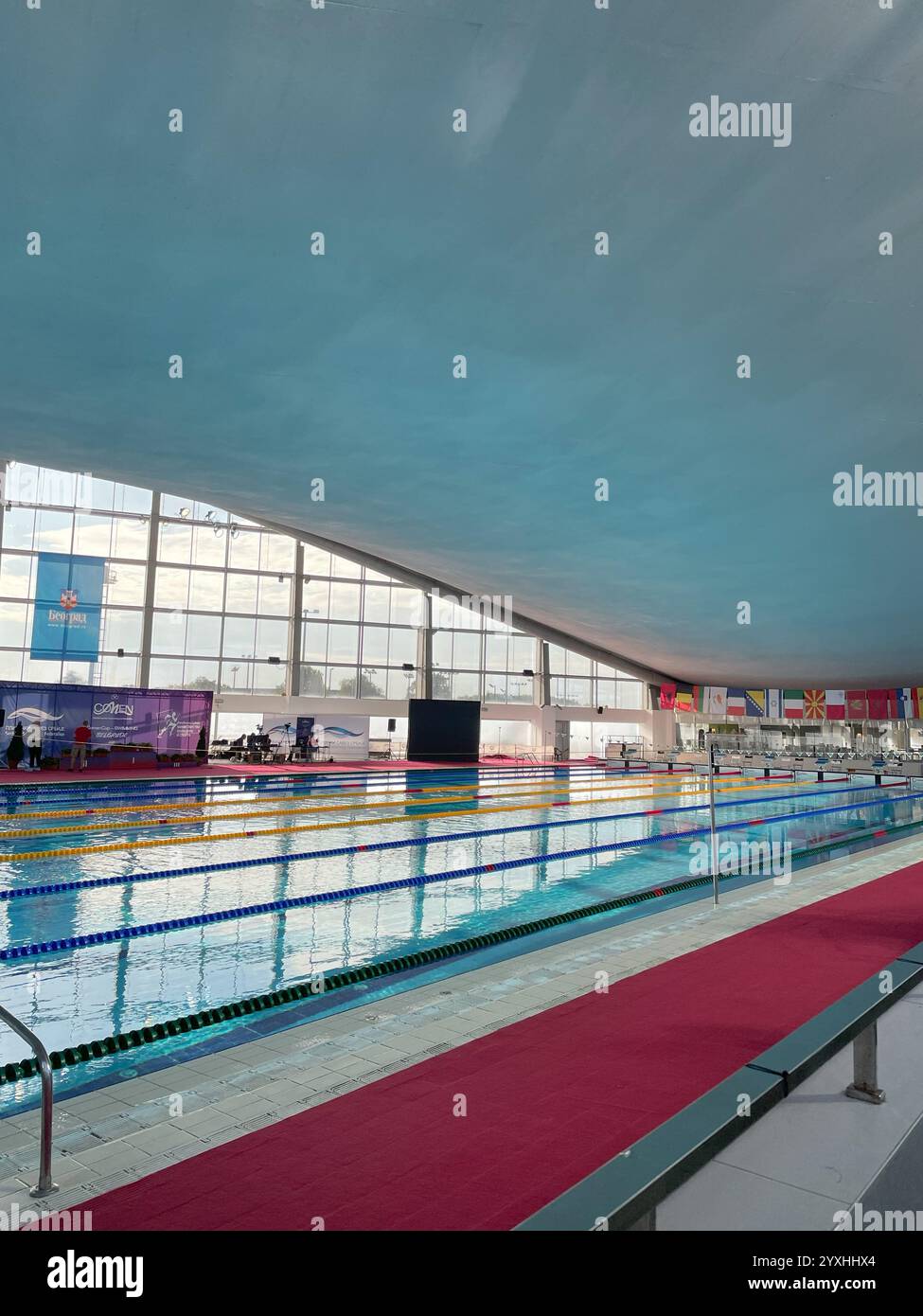 This photograph showcases a modern indoor Olympic swimming pool in ...
