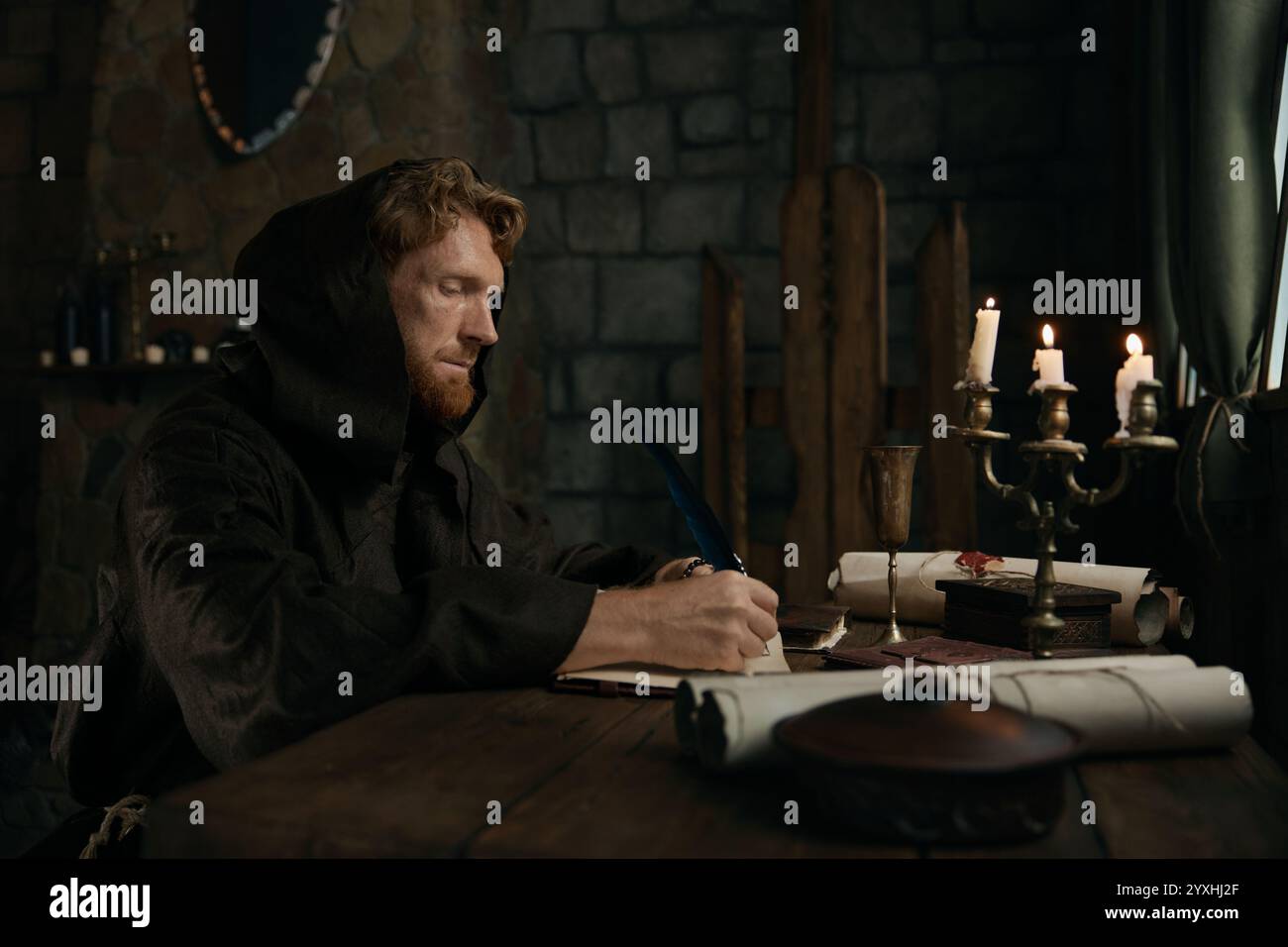 Medieval monk chronicler writing ancient manuscript under candlelight ...