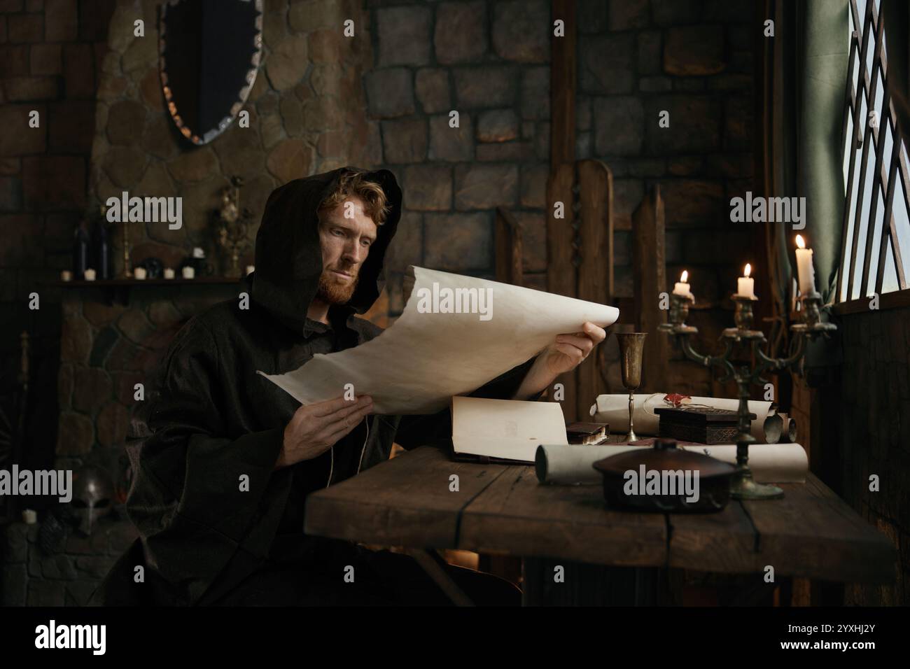 Medieval monk wearing robe with hood reading sacred manuscript on ...