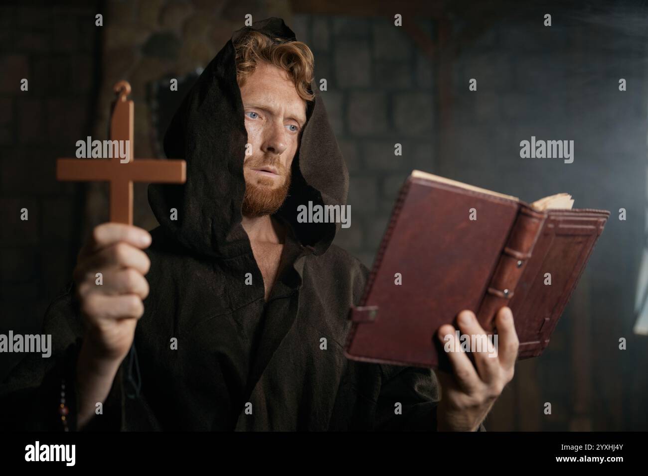 Priest holding cross and holy bible performing exorcism rite Stock ...