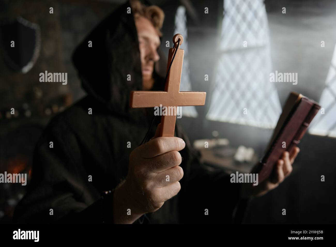 Priest holding cross and holy bible performing exorcism rite Stock ...