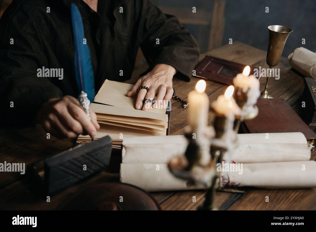 Medieval monk writing historic manuscripts at table Stock Photo - Alamy